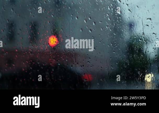 Rain Drops Falling on window with bokeh light effects. Heavy rain ...