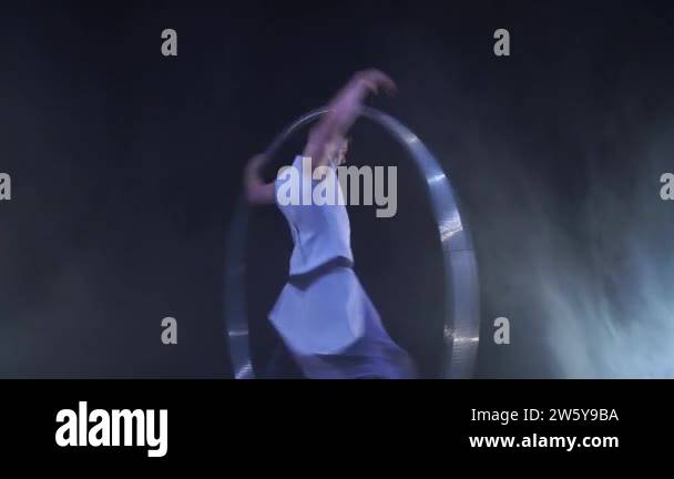 Circus artist shows concentration and balance while spinning on a Cyr ...