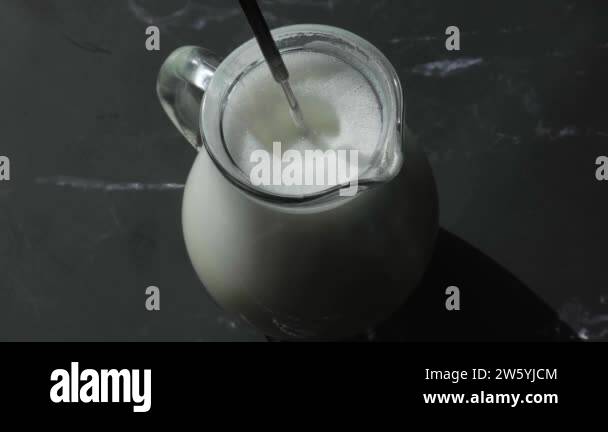 Beat the milk in a mug using a frother. Hand mixer for milk. Making ...