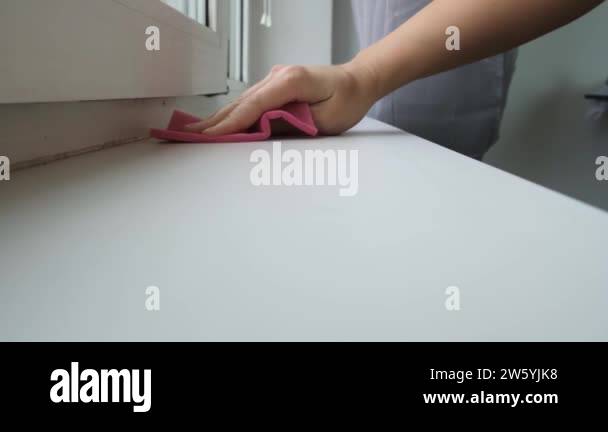 Cleaning washing window sill with a duster by a womans hand, washing ...