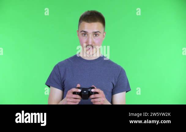 Portrait Of A Young Man Playing A Video Game Using A Wireless