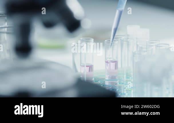 Scientist Mixing Chemicals Under Microscope Stock Video Footage - Alamy