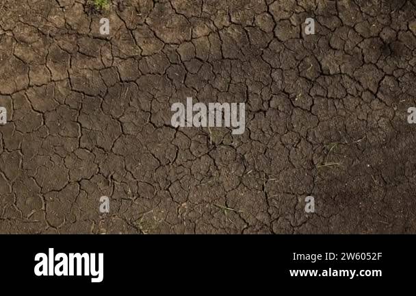 Cracked soil ground of dried lake or river in mountains. Land destroyed ...