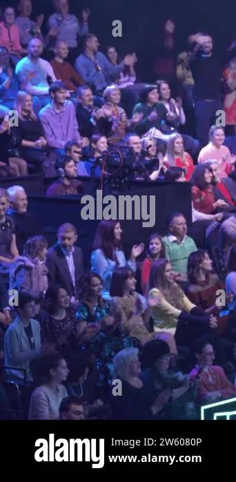 People viewers in a TV studio while recording a TV show. Vertical video ...