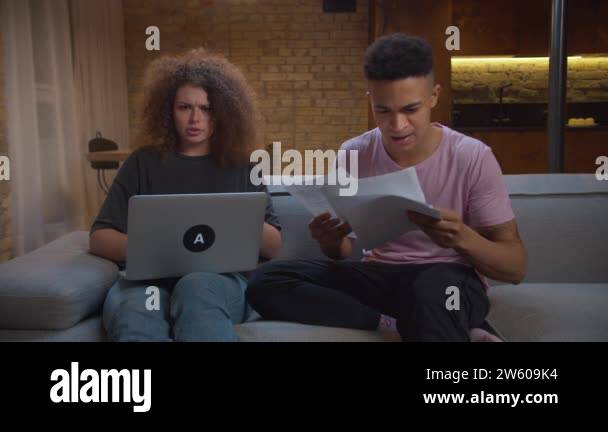 Young African American man giving high five to girlfriend after passing ...