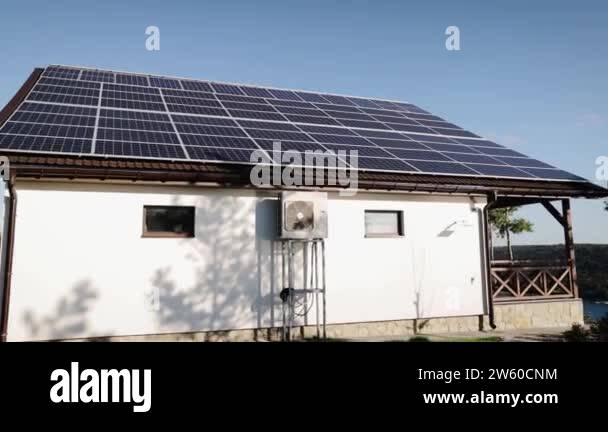 New modern residential house with blue shiny solar photovoltaic panels ...