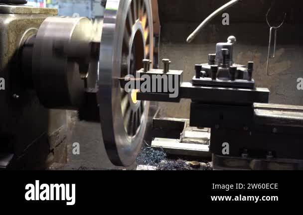 Lathe Machine Processing A Metal Part In A Train Factory. Process Of ...