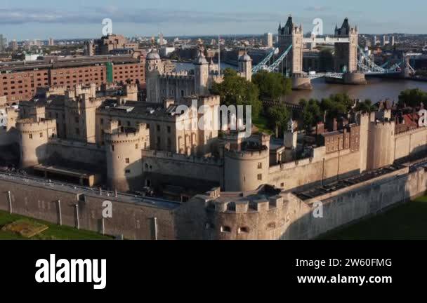 Forwards fly above Tower of London in golden hour. Impressive stone ...