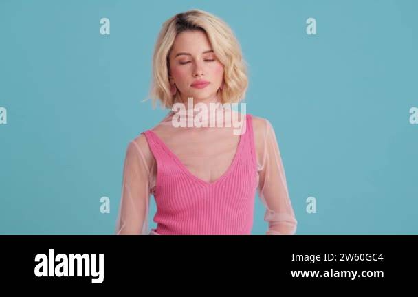 Boring handsome woman rolling her eyes and clapping hands while chewing ...