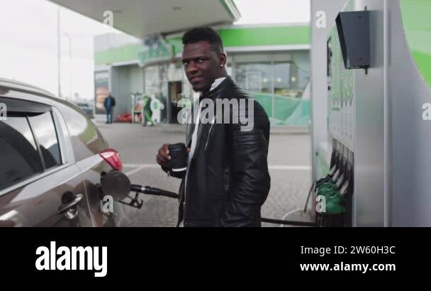 Portrait Of An African Guy At A Gas Station With Coffee In Hands ...