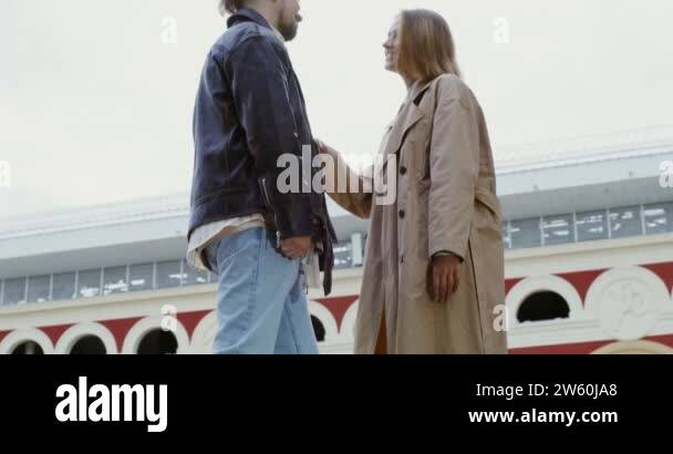 A young couple is walking along the parapet holding hands and stopping for kiss Stock Video ...