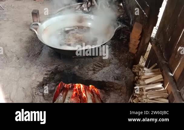 Traditional process of making palm sugar, cooking raw palm extract on ...