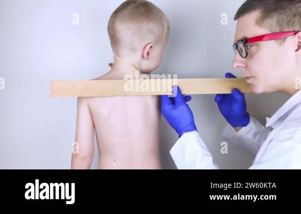 A little boy at the doctor's appointment with back pain. Treatment of ...