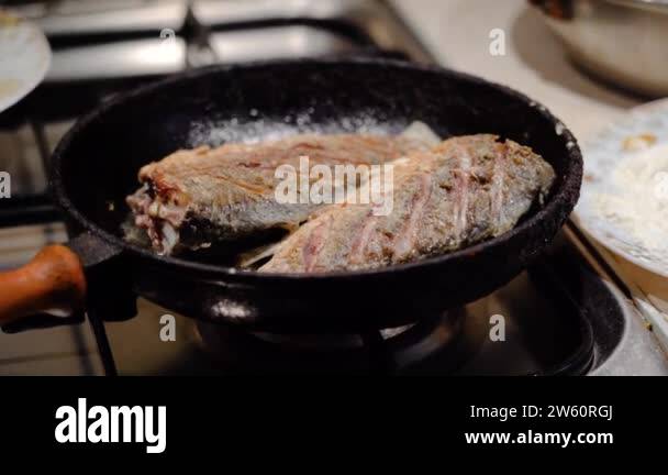 Carp fish is fried in a pan. Freshwater fish crucian carp. Recipe ...