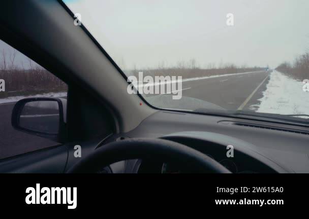 Viewing from car interior through windshield on passing by heavy truck ...