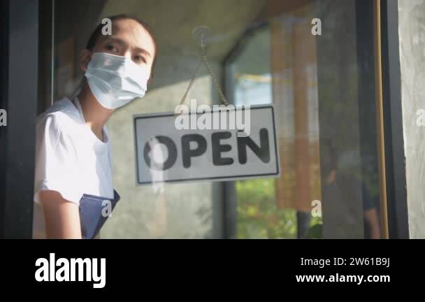 Coffee shop concept of 4k Resolution. Asian girl is flipping the sign ...