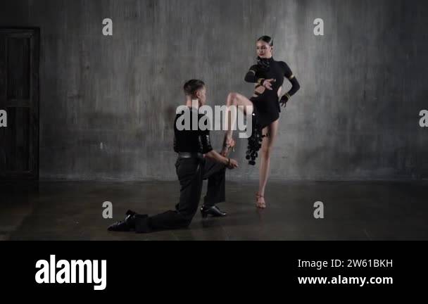 Young elegant millennial dance ballroom couple in black dress dancing ...