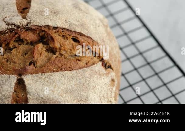 Close up camera movement. Beautiful rustic rye bread lies on the wire ...