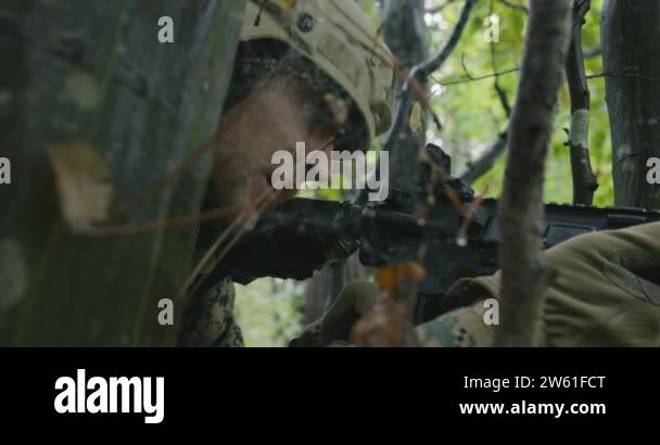 Fully equipped rifle soldier wearing camouflage uniform attacking enemy ...