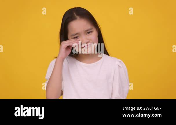 Kids problems. Portrait of upset asian girl crying and wiping her tears ...