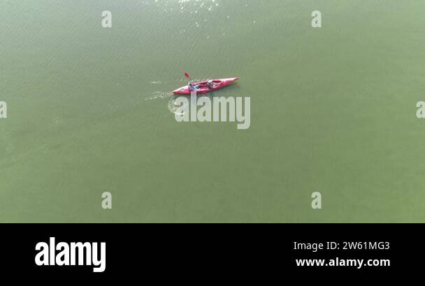 Canoe in the lake. Canoe with two people floats on the river top view. Flying over people in a ...