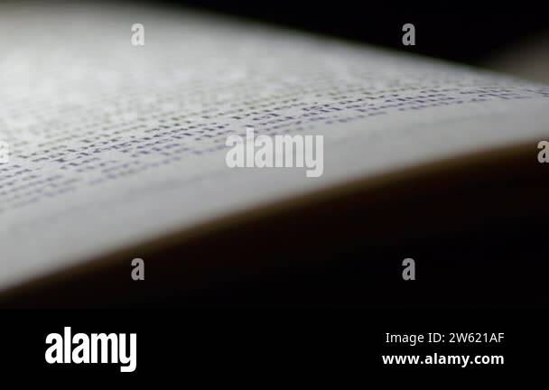 Pages written of a open book turning with black background, rotation ...