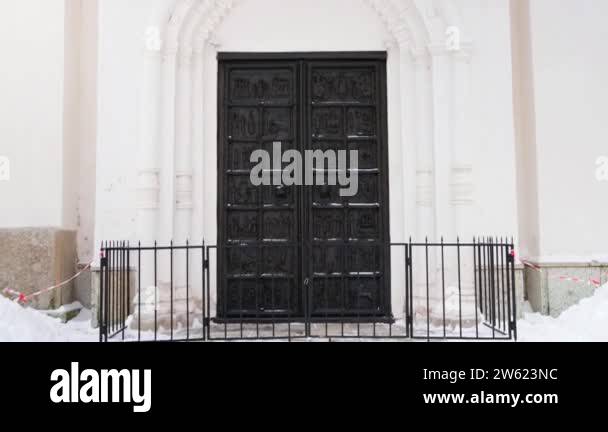A steel black heavy door and an arch of a traditional orthodox church ...