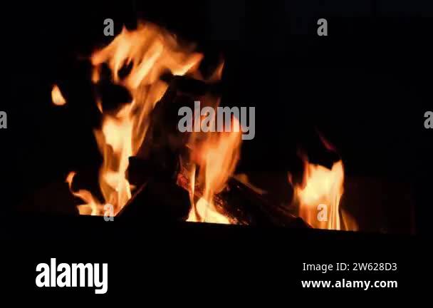 a fire is burning in the night, you can see burning boards, the flame ...
