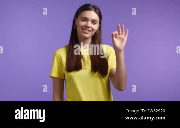 Woman showing Ok sign over violet studio background. Positive young ...