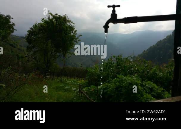 Natural spring water and fountain, tap water flowing through the pipe ...