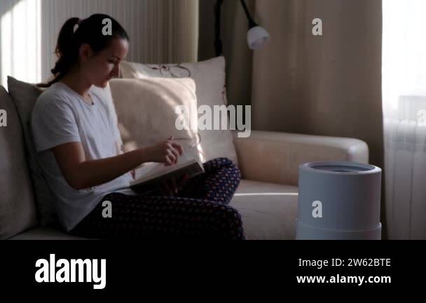 Modern air humidifier, aroma oil diffuser at home. Improving the comfort of living in a house ...