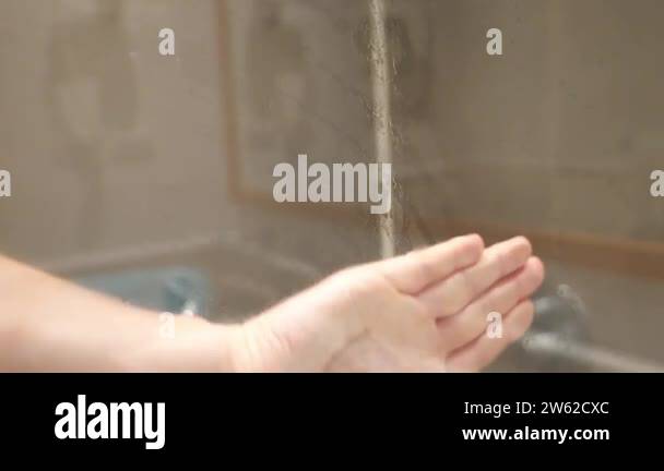 misted glass in the shower. womans hand wipes misted glass Stock Video ...