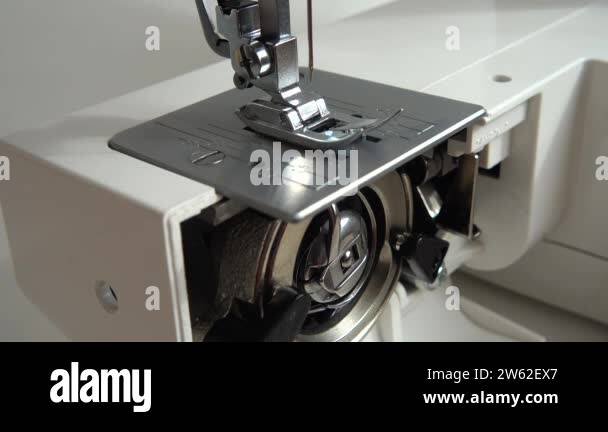 The needle of a sewing machine makes a thread stitch. Elements of the ...