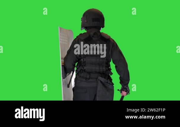 Riot police unit walking with a shield and baton on a Green Screen ...