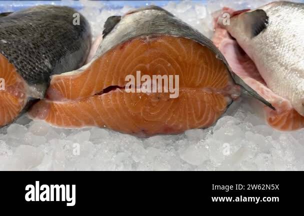 Close Up of fresh fillets salmon in a supermarket refrigerated display ...