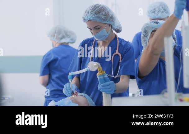 The anesthesiologist and medical team prepares female patient for ...