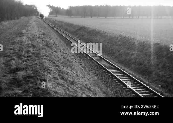 Vintage steam locomotive with old wagons on trail. Black and white ...