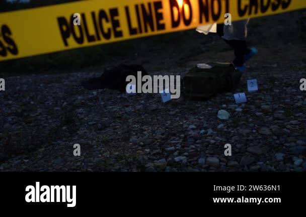 Forensic police investigator collecting evidence at the crime scene by ...