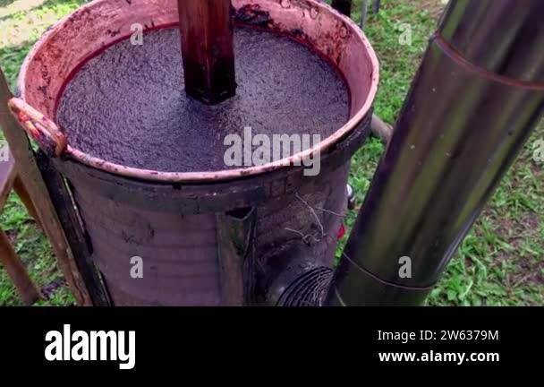 Cooking plum jam in traditional cauldron with mixer. Authentic process ...