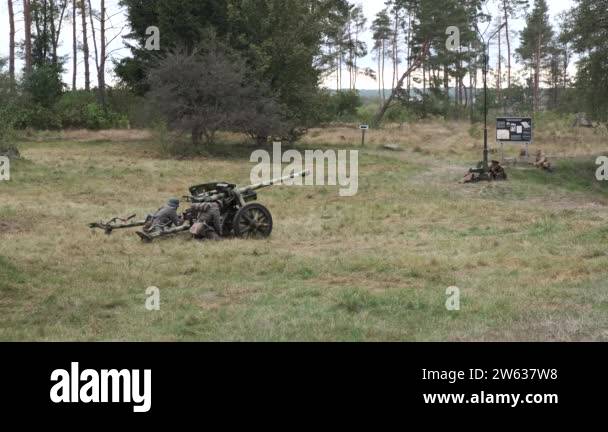German soldiers of the Wehrmacht shoot from an anti-tank artillery gun ...