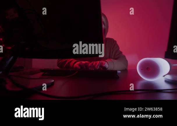 Anonymous person in a white mask works on the computer, inputs code ...