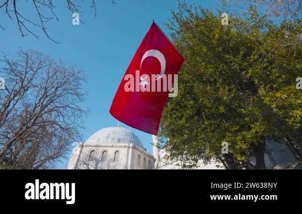 Turkish flag on background of mosque. Action. Turkish flag is flying in ...