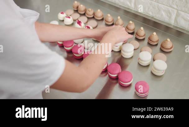 Typical process of connecting two halves of macaron with cream filling ...
