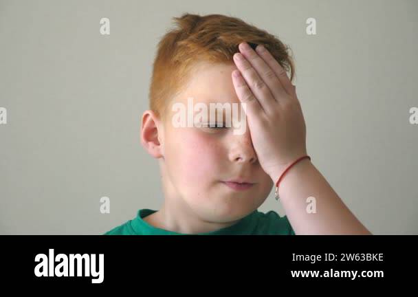 Portrait of serious red hair boy with freckles. Desperate kid thinks ...