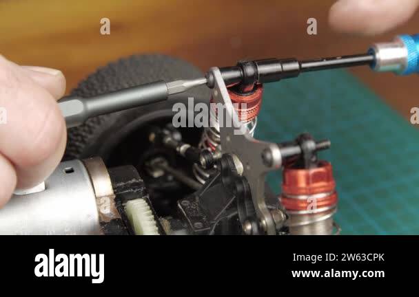 Close-up radio control model buggy car. The hands of the master ...