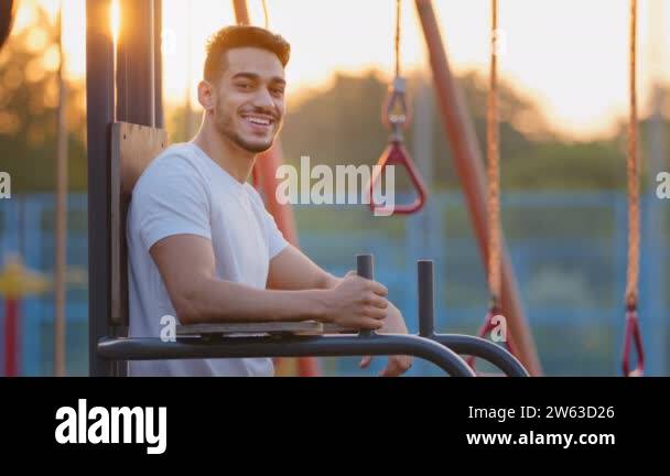 Attractive millennial Middle Eastern Arab athletic guy shows biceps ...