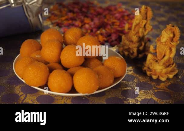 Offering a laddu / prasad to God on Diwali . Beautiful clay idols of ...