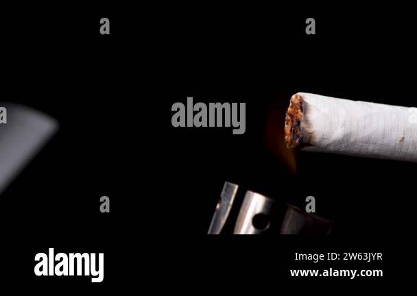 Real time light a cigarette with fire, extreme close-up, black backdrop ...