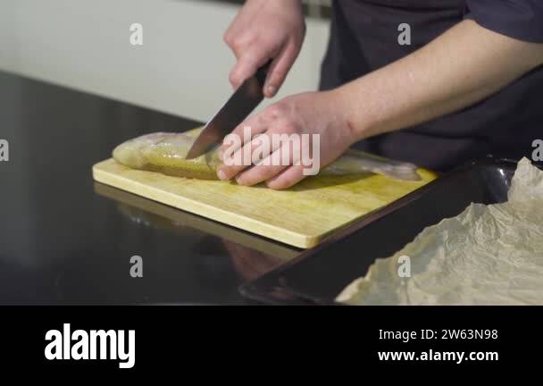 Close-up of cook cutting fish. Art. Professional chef makes cuts on ...