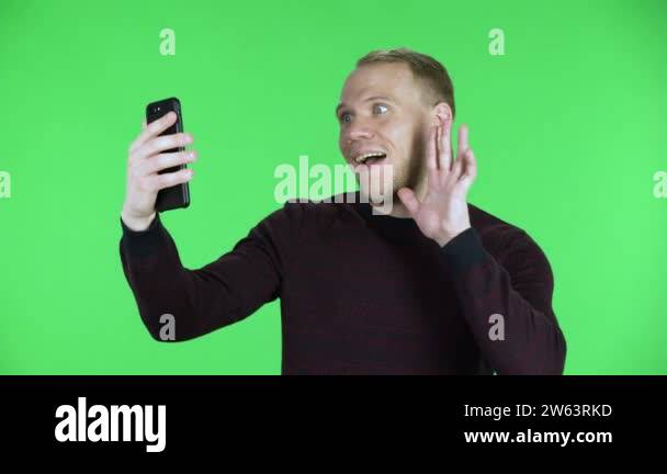 Portrait of a middle aged men talking with delight and joy via video ...